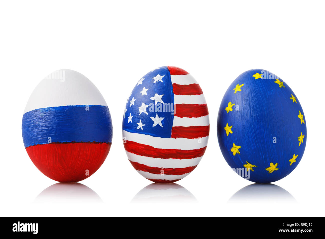 Three Easter eggs painted in the colors of flags of Russia, America and ...