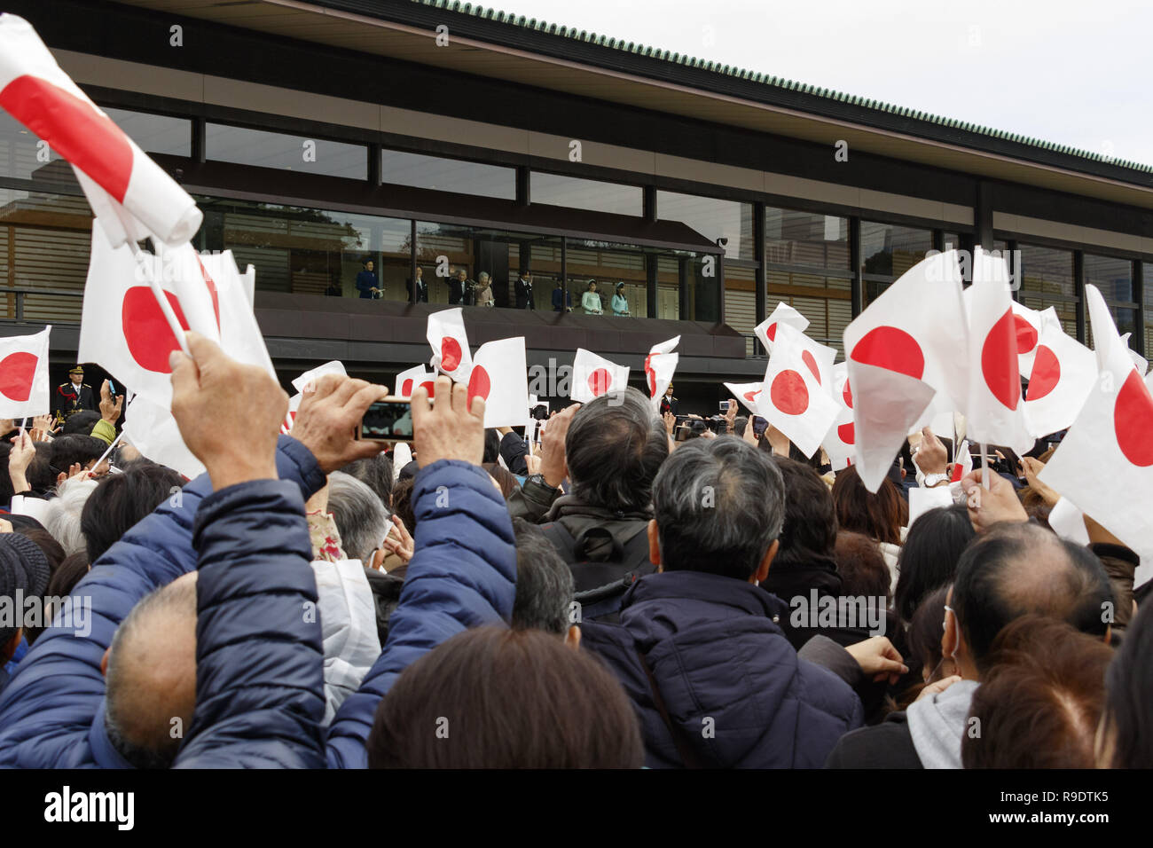 Tokyo, Japan. 23rd Dec, 2018. Well-wishers waving Japanese flags greet ...