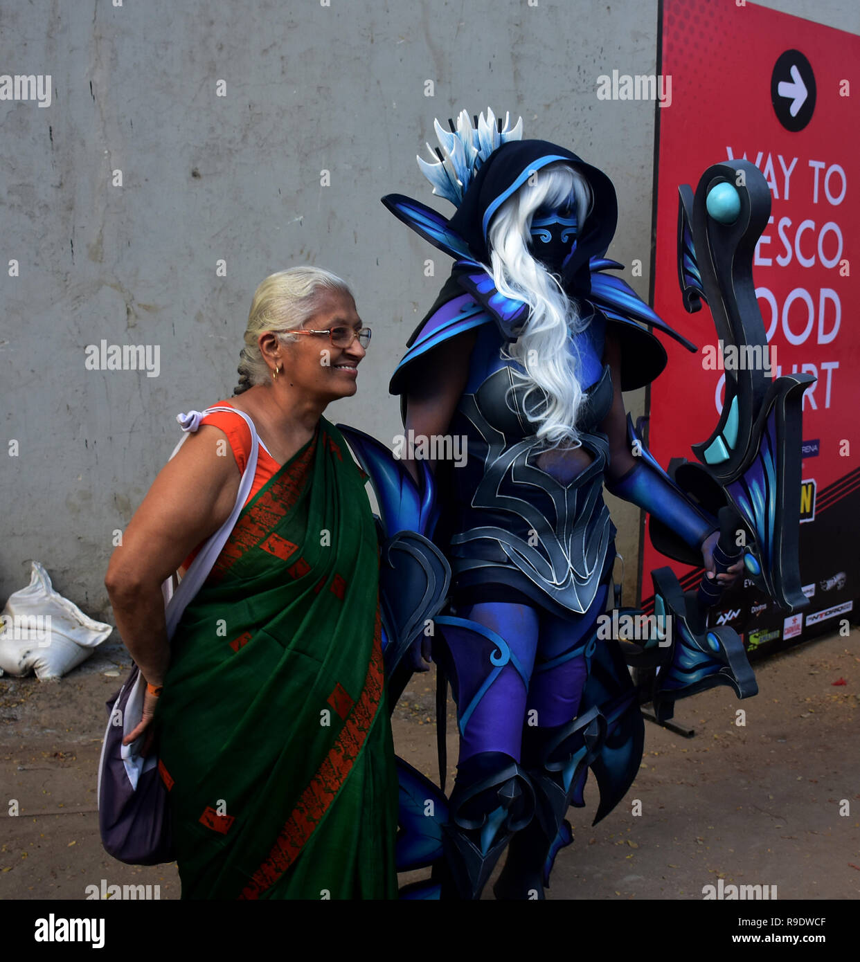 An old lady seen posing for a photo with a cosplayer during the eighth ...