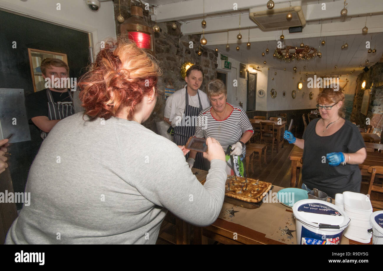 Mousehole, Cornwall, UK. 23rd Dec, 2018. A visitor to the ship Inn ...
