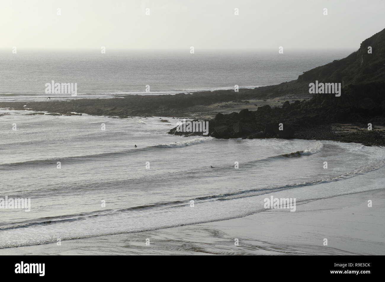 Surfing at Pwlldu Bay on the south Gower Peninsula coast in south Wales ...