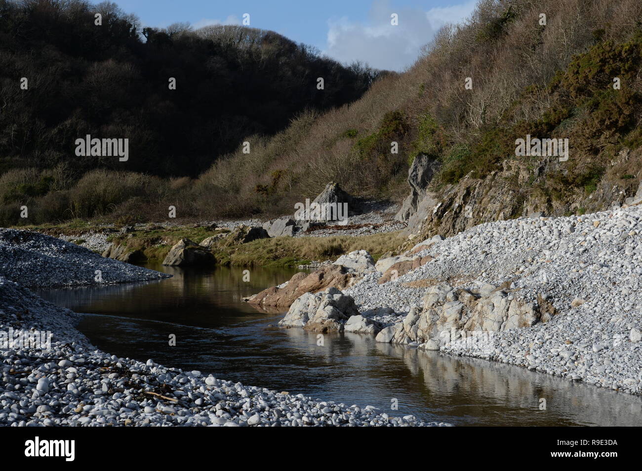 The valley at Pwlldu Bay with pebble bank at the high tide mark, south ...
