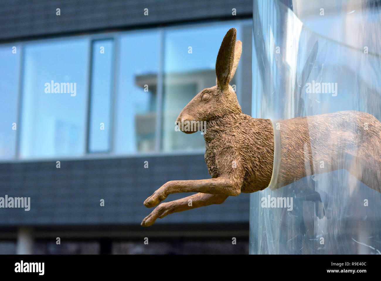 Sculpture of a bronze rabbit jumping through a glass hoop by artist ...