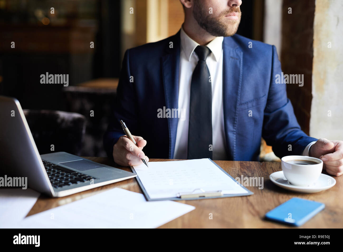 Confident young businessman checking hi-res stock photography and ...