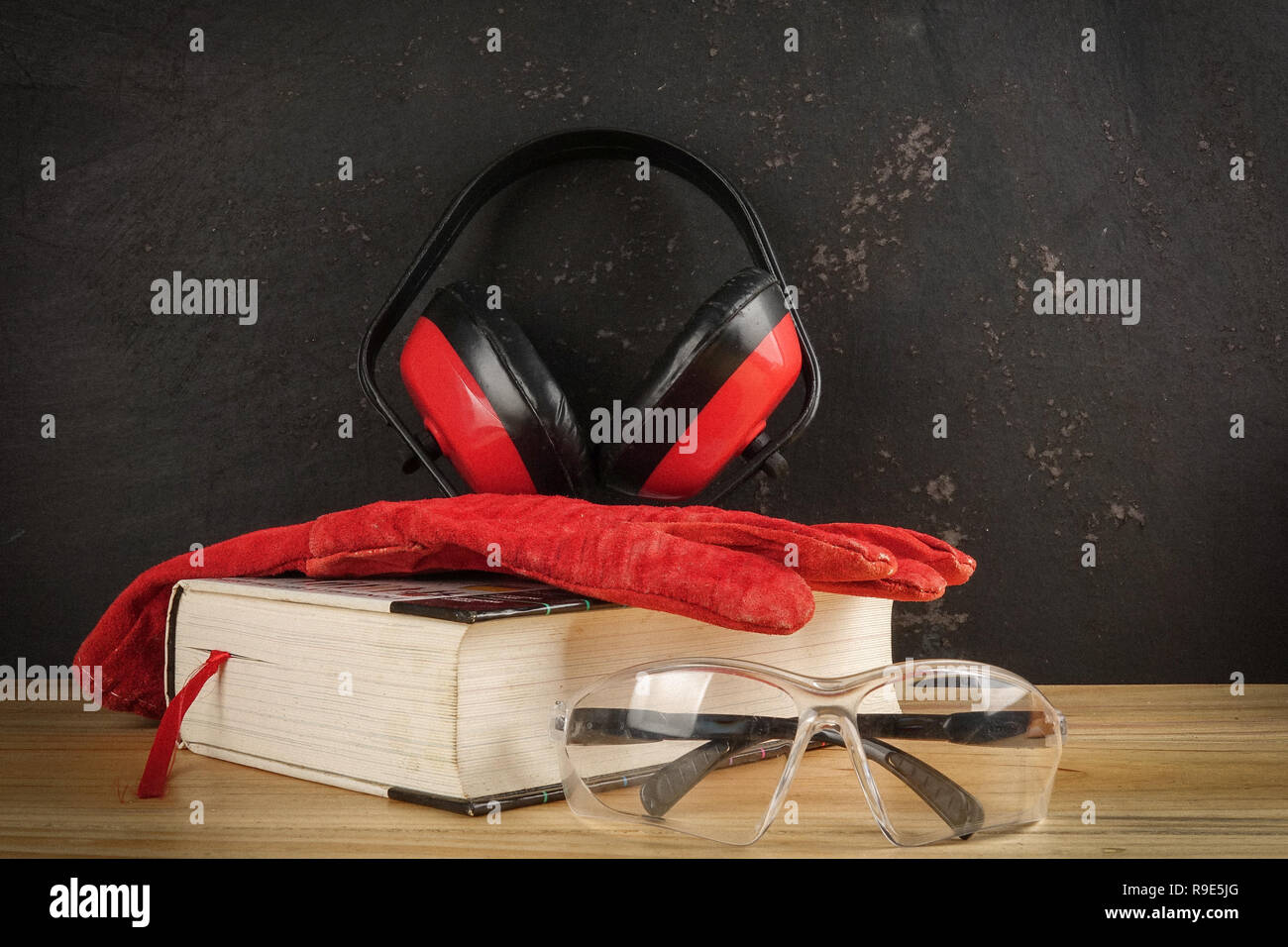 Safety Personal Protective Equipment(PPE) on a rustic black background ...