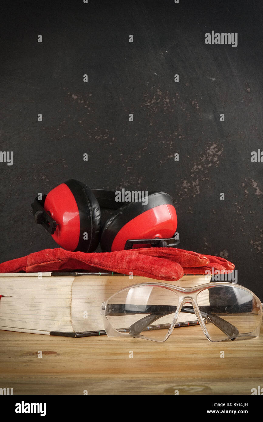 Safety Personal Protective Equipment(PPE) on a rustic black background ...
