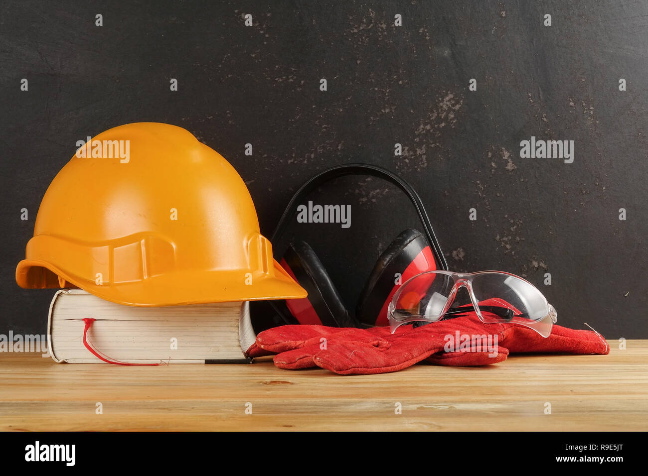 Safety Personal Protective Equipment(PPE) on a rustic black background ...