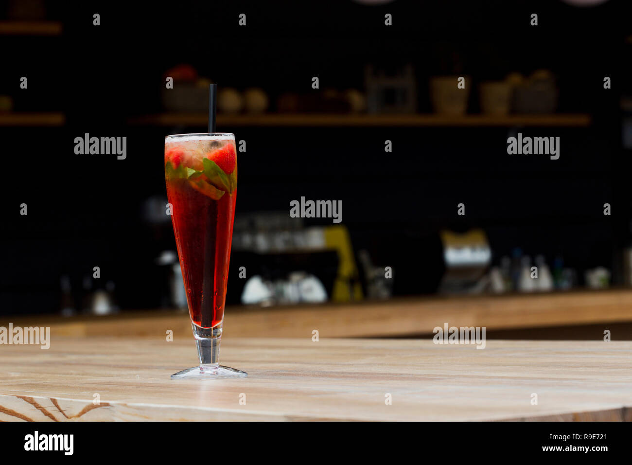 Cold lemonade with strawberries, mint and ice on the outdoor veranda ...