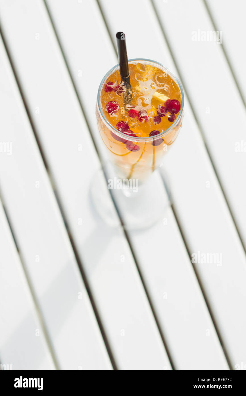 Cold lemonade with cranberries, ginger and ice on the outdoor veranda ...