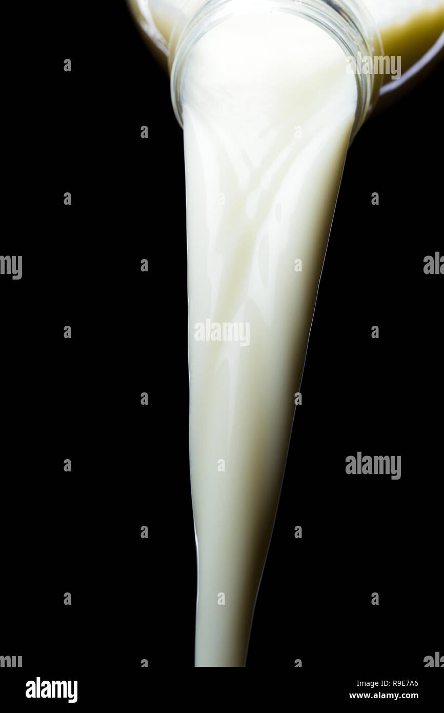 Fluffy natural milk on a black background, studio light Stock Photo - Alamy