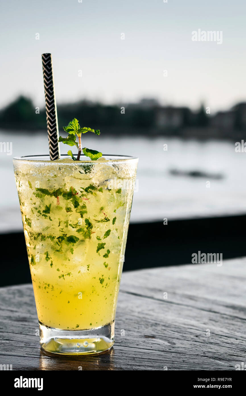orange mojito summer cocktail drink on outdoor riverside bar tabe Stock ...