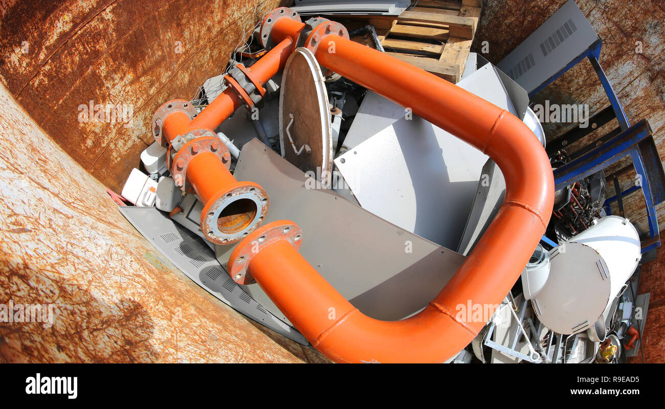 big old iron pipe in the recycle container with many pieces of old ...