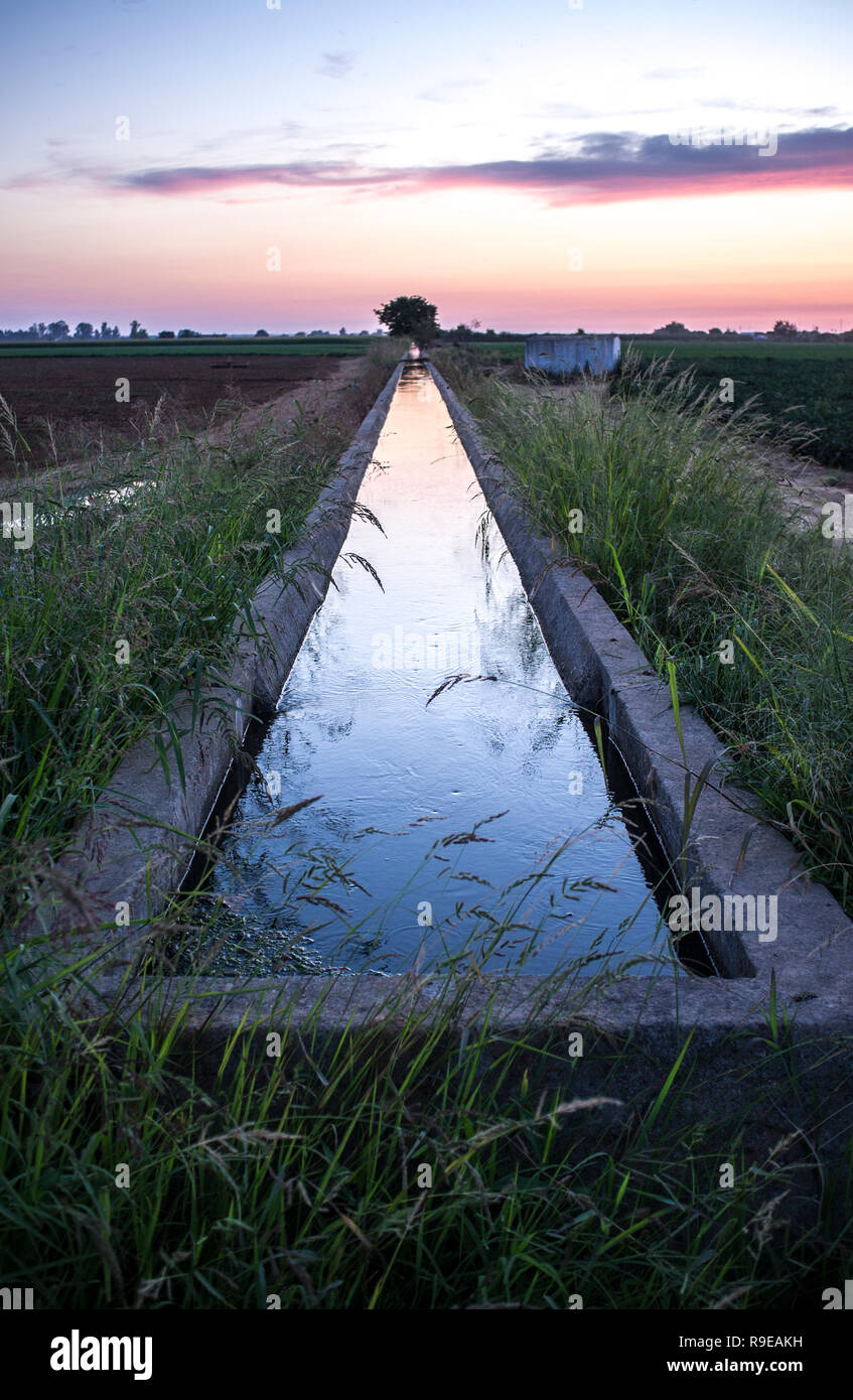 Concrete irrigation canal at sunset. Low Guadiana Lands, Extremadura ...