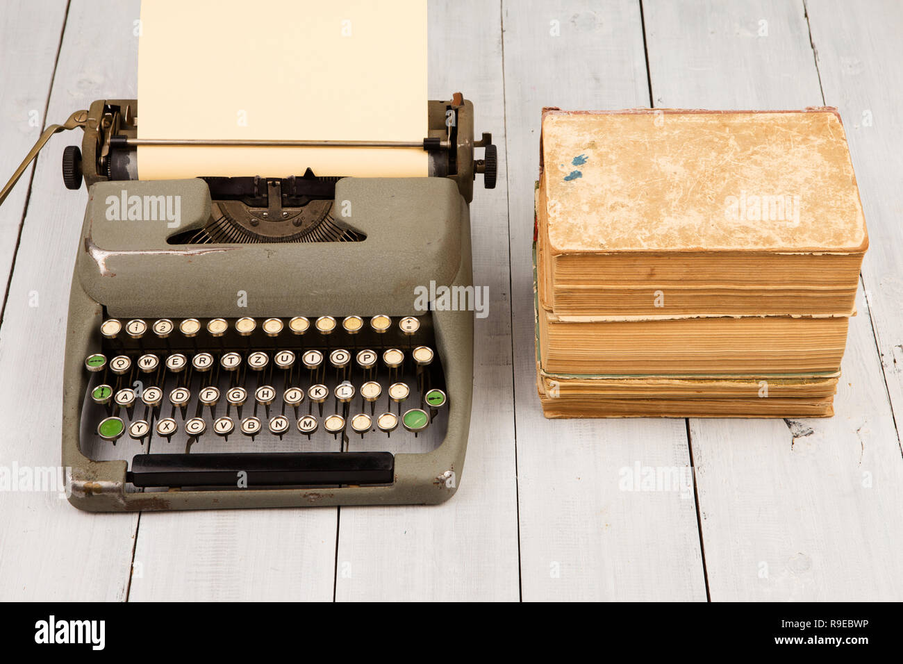 Retro typewriter and old vintage books on white wooden background Stock ...
