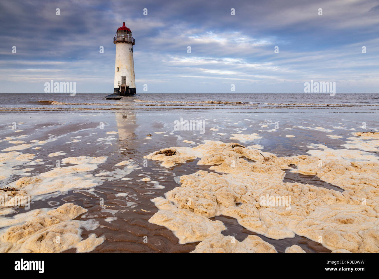 Point of Ayr lighthouse with pollution on Talacre beach, North Wales ...