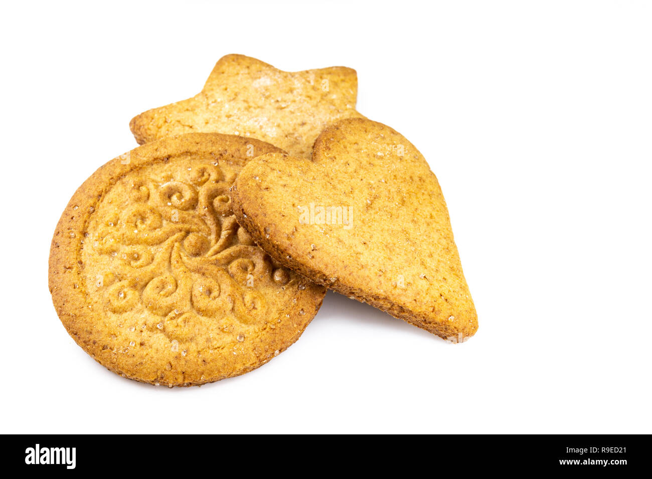 Three pieces of round, heart and star shaped gingerbread with patterns ...
