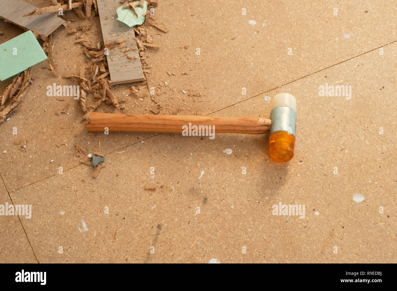 Hammer for laminate installation and remains of slices laminate on the ...