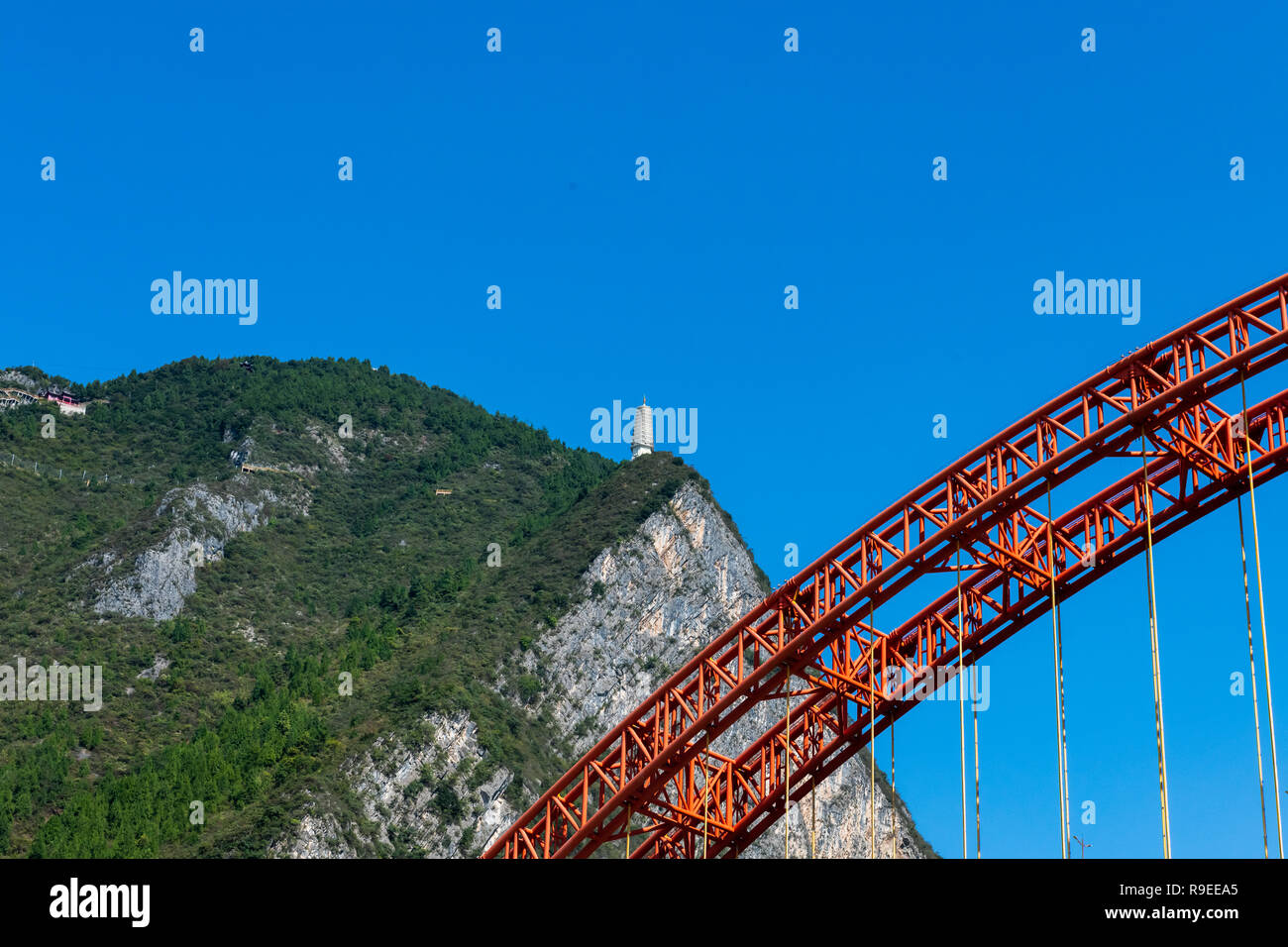 Wushan river bridge - partial view of span with white pagoda in distant ...