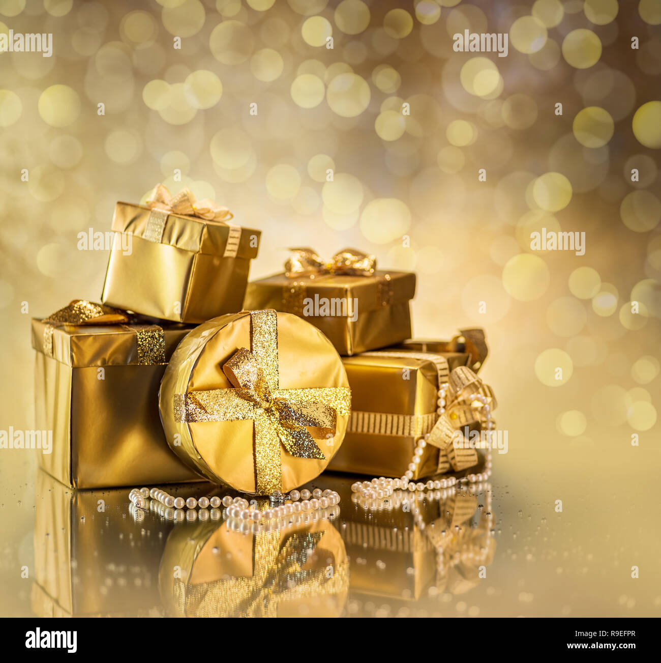Golden gift boxes as a symbol of wishes and celebration. Golden blurred ...