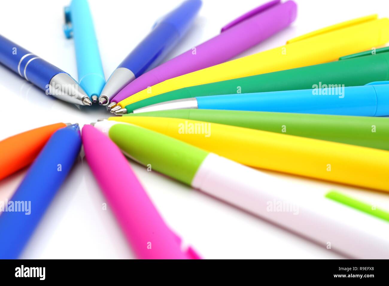 Multi colored ball pens on white background Stock Photo - Alamy