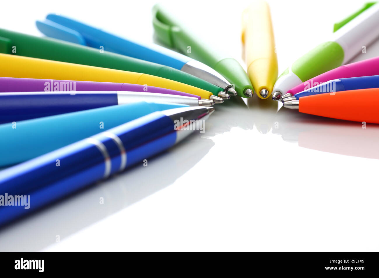 Multi colored ball pens on white background Stock Photo - Alamy