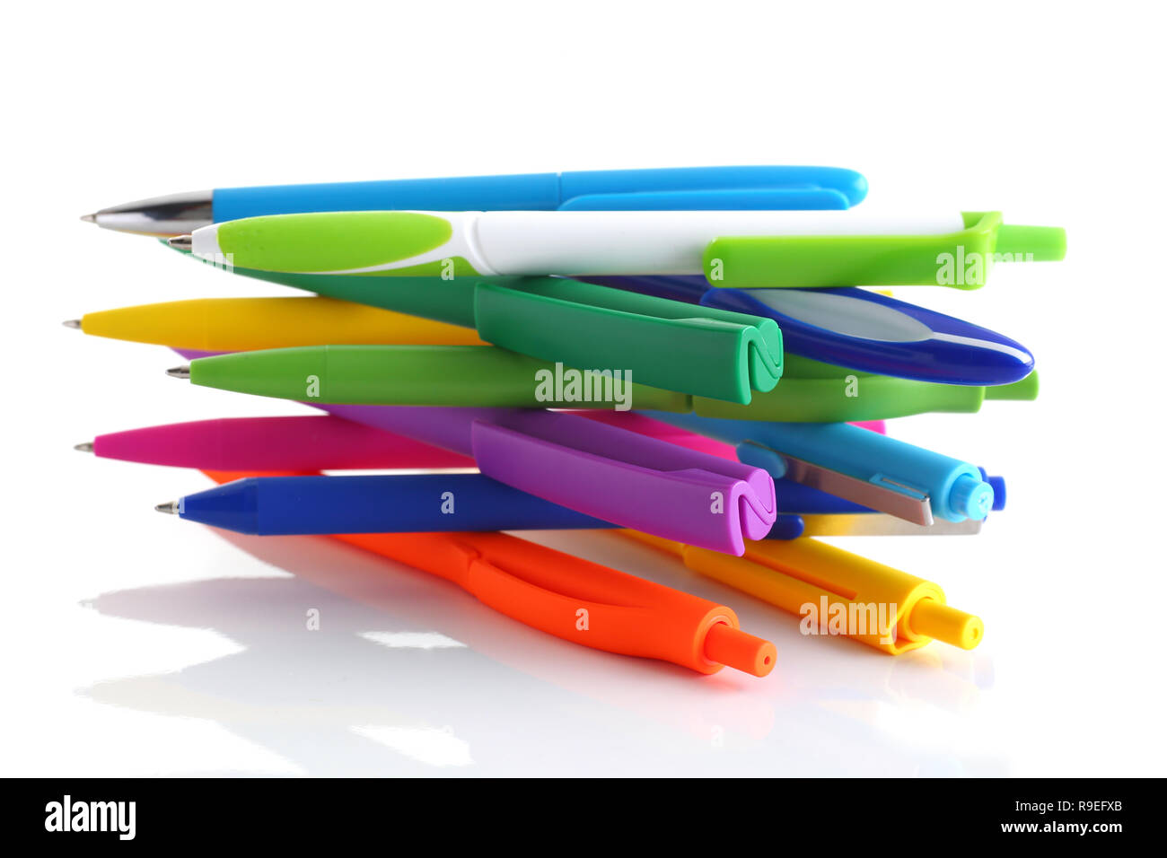 Multi colored ball pens on white background Stock Photo - Alamy