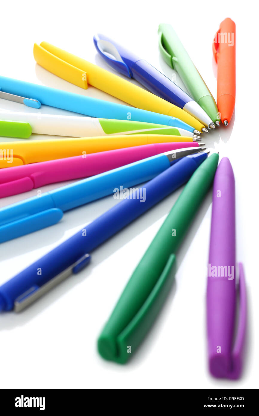 Multi colored ball pens on white background Stock Photo - Alamy