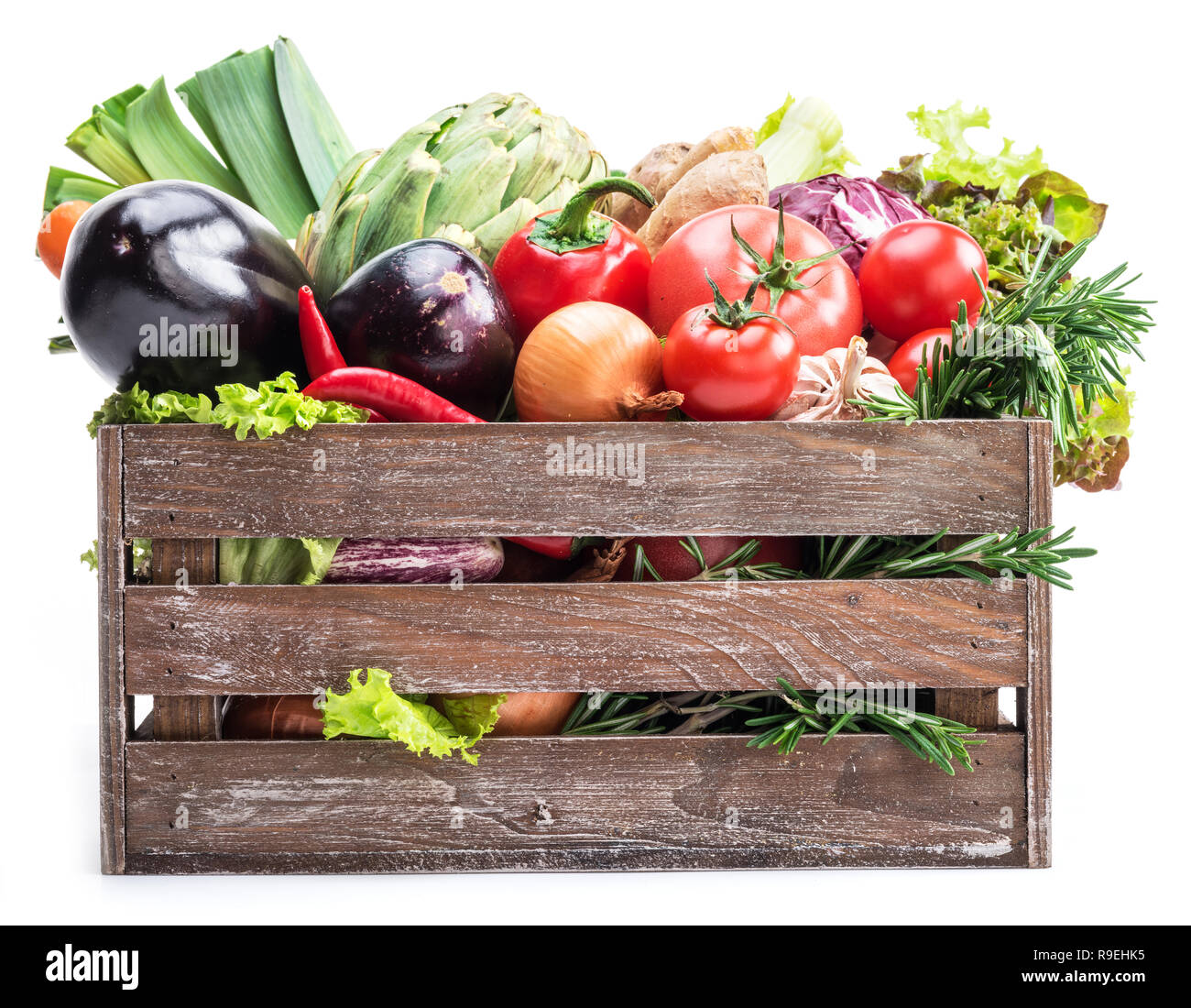 Fresh multi-colored vegetables in wooden crate. White background Stock ...