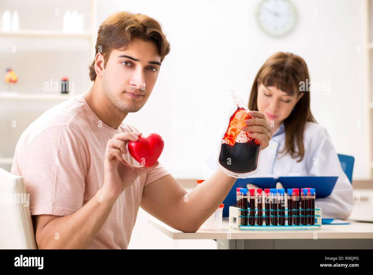 Man giving his blood as a donor Stock Photo - Alamy