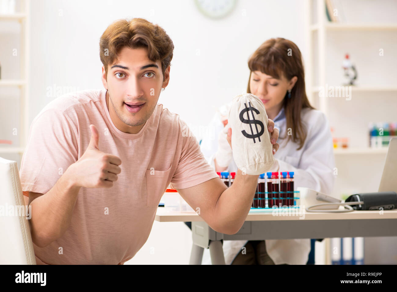 Man giving his blood as a donor Stock Photo - Alamy