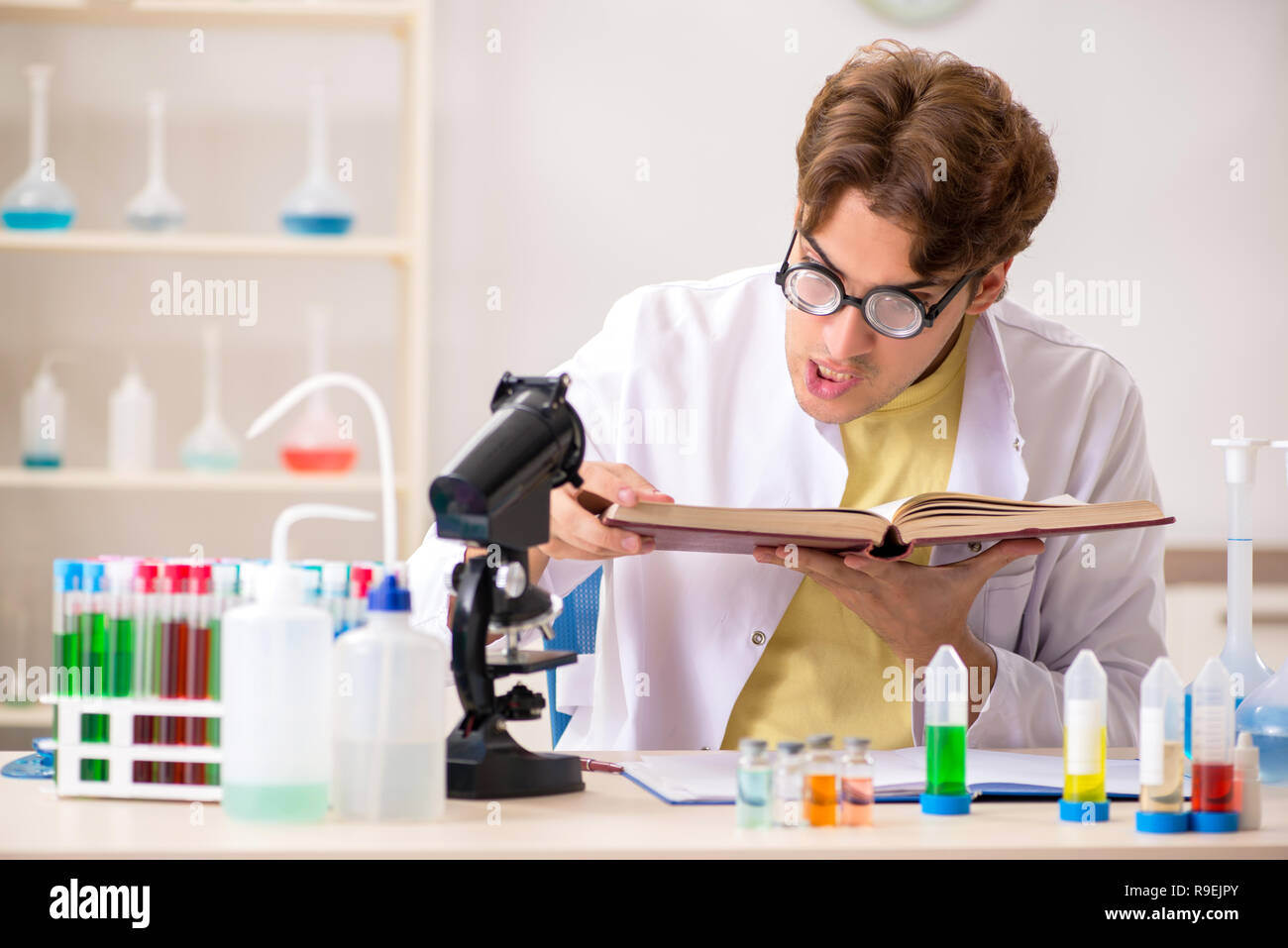Funny crazy chemist doing experiments and tests Stock Photo - Alamy