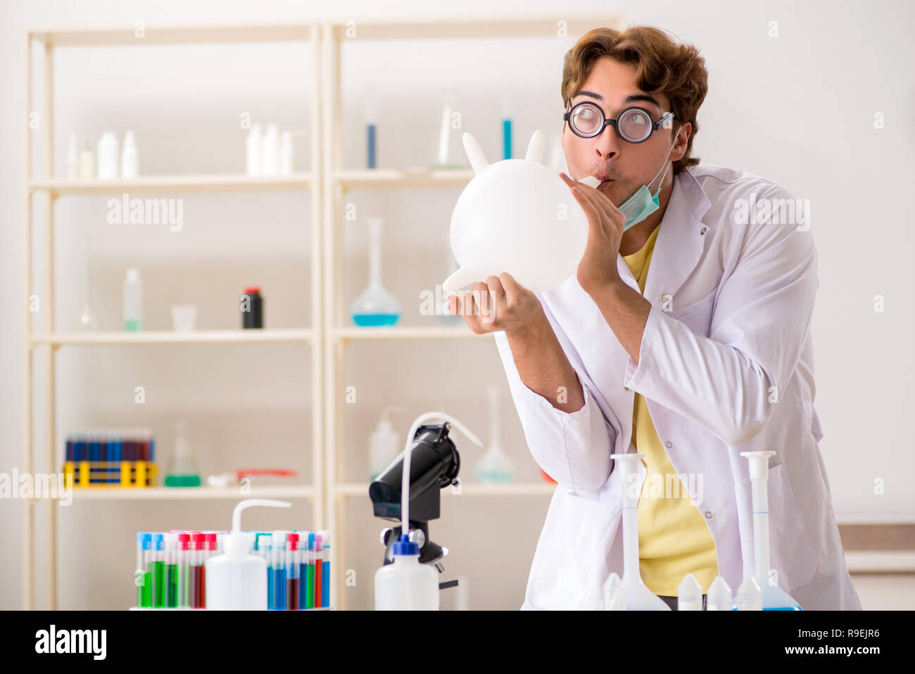 Funny crazy chemist doing experiments and tests Stock Photo - Alamy