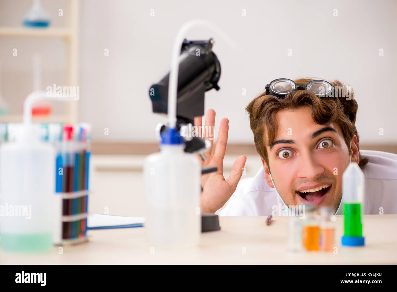 Funny crazy chemist doing experiments and tests Stock Photo - Alamy