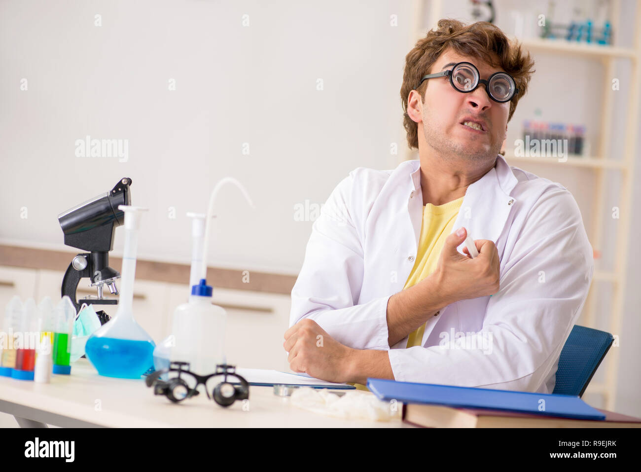 Funny crazy chemist doing experiments and tests Stock Photo - Alamy