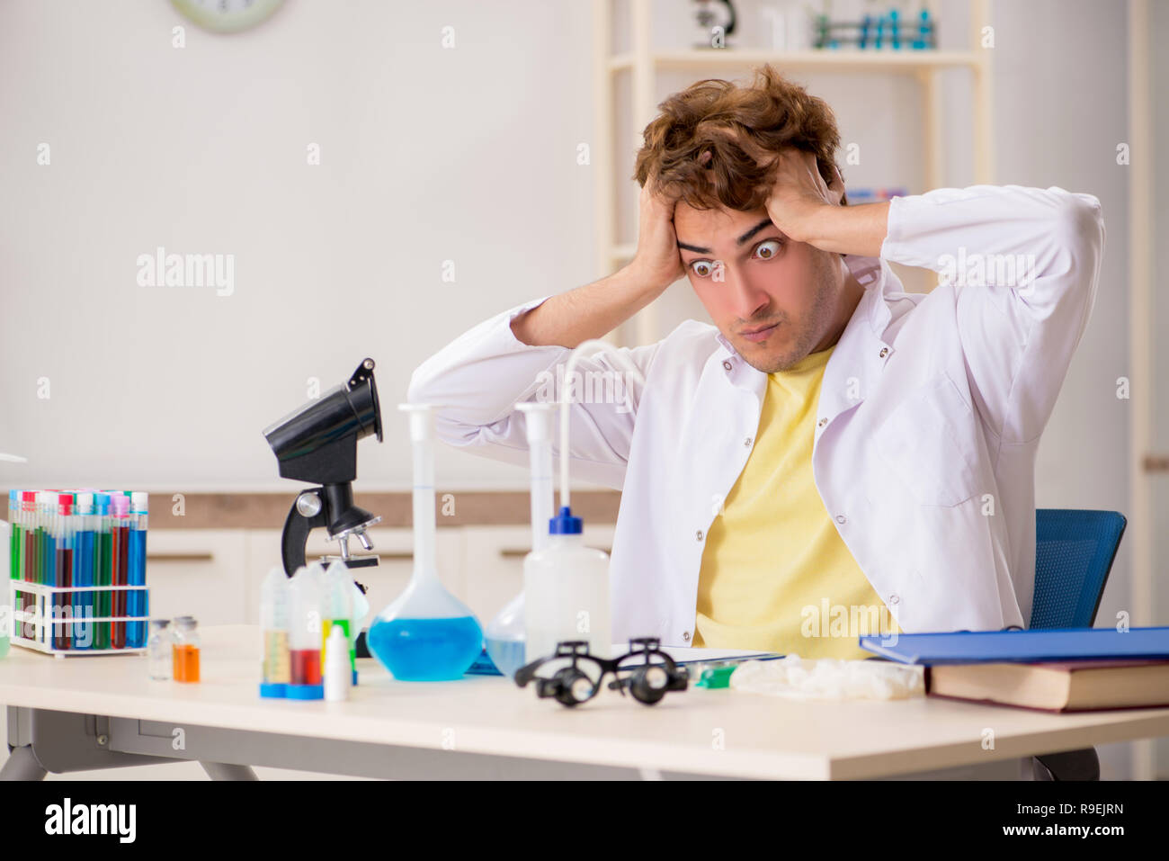 Funny crazy chemist doing experiments and tests Stock Photo - Alamy