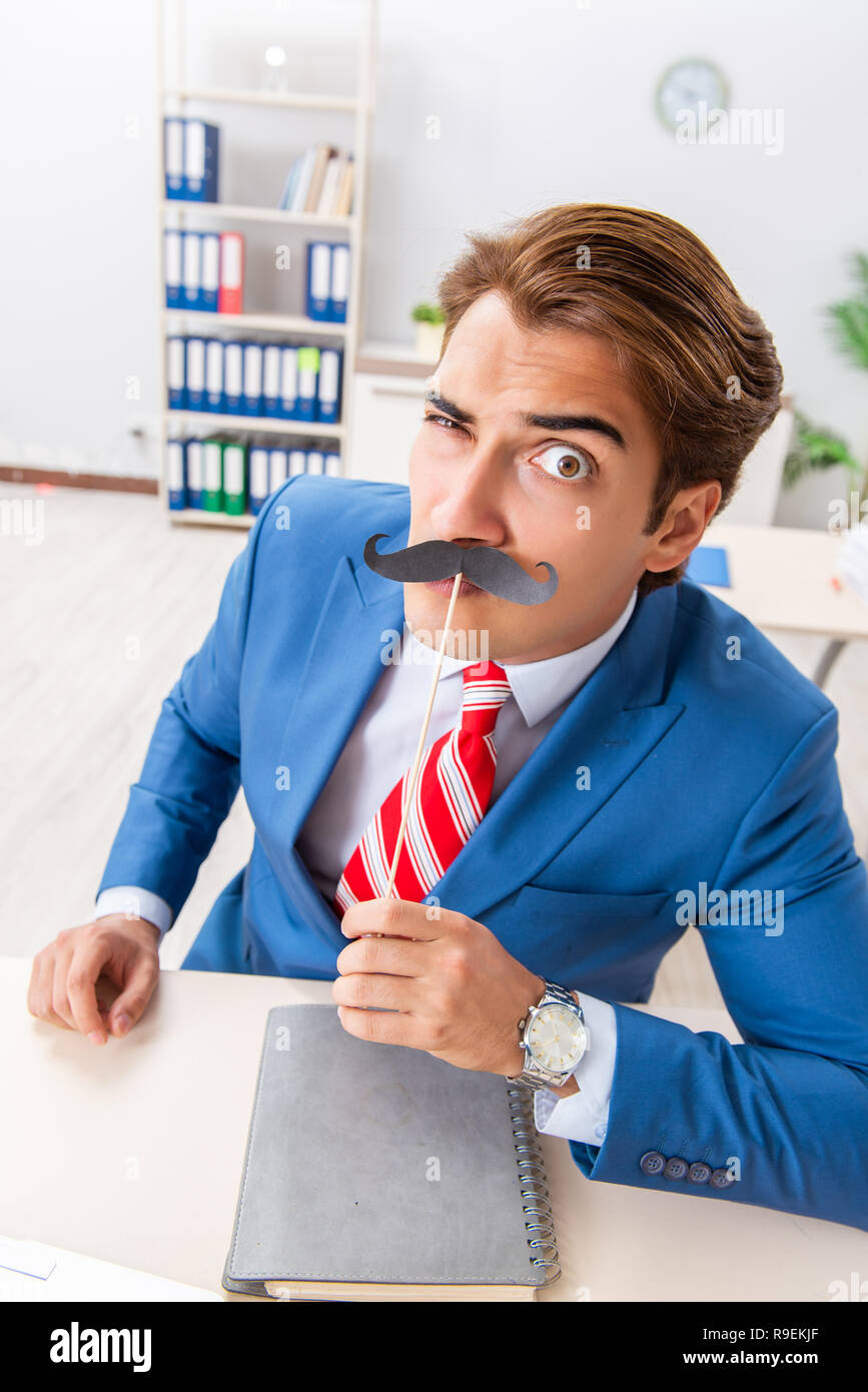 Funny bisinessman with fake moustache in the office Stock Photo - Alamy