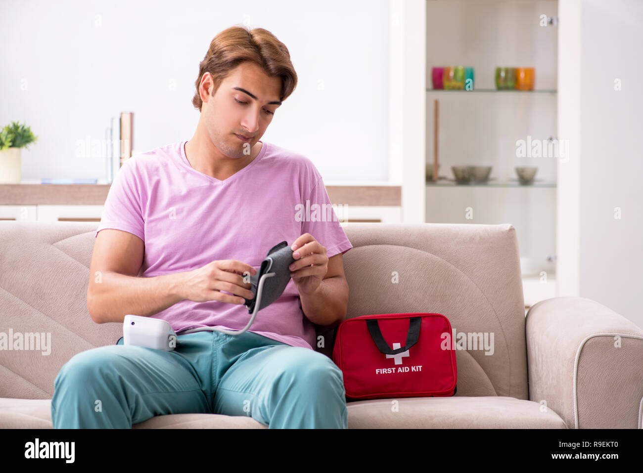 Sick man at home with first aid kit Stock Photo - Alamy