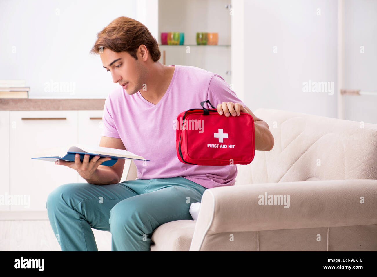 Sick man at home with first aid kit Stock Photo - Alamy