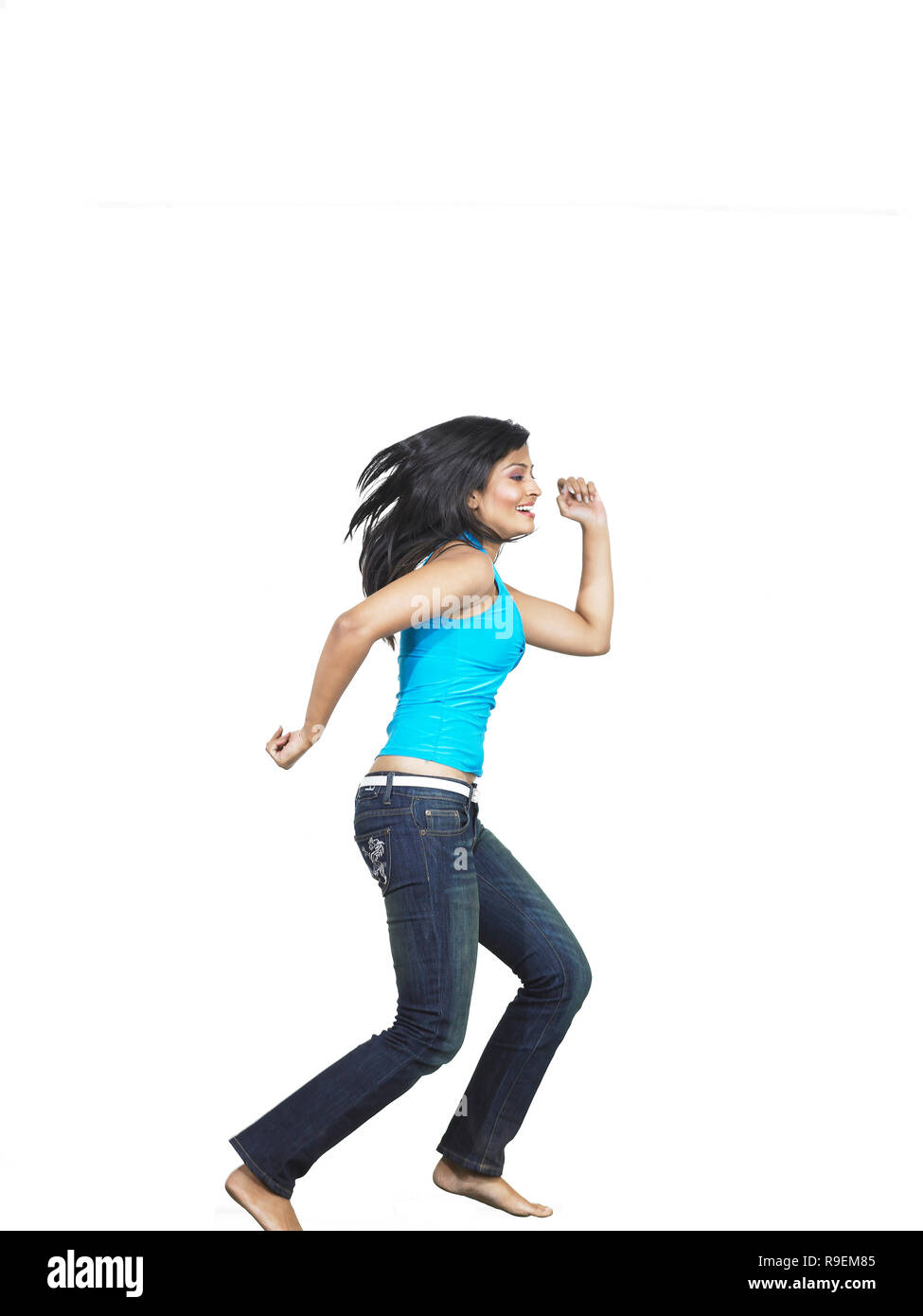 WOMAN JUMPING IN EXUBERANCE AGAINST A WHITE BACKGROUND Stock Photo - Alamy