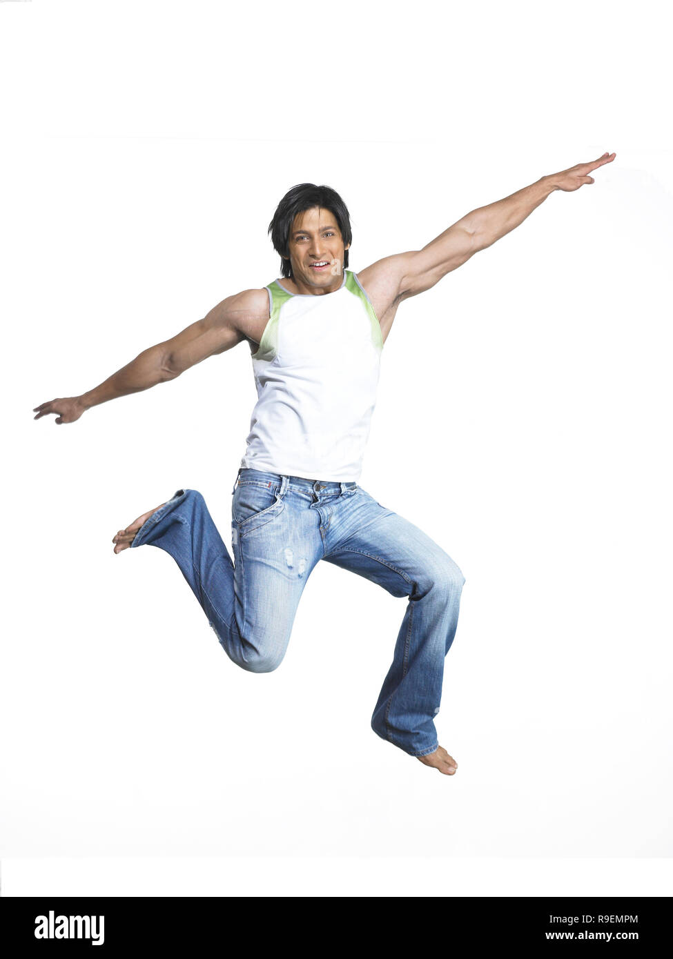YOUNG MAN JUMPING IN EXUBERANCE AGAINST A WHITE BACKGROUND Stock Photo ...