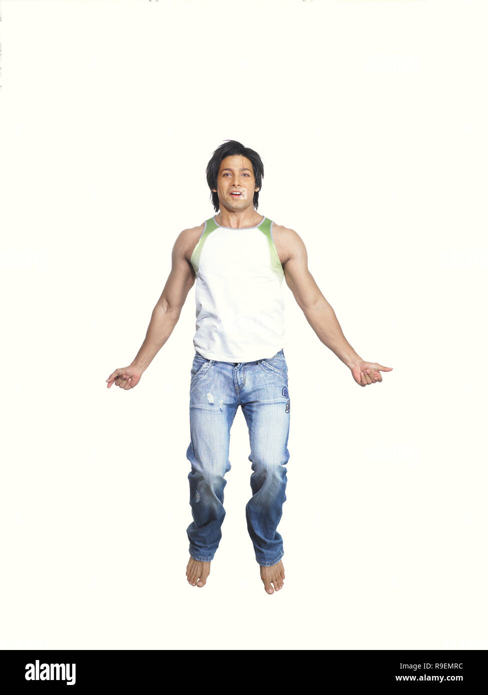 YOUNG MAN JUMPING IN EXUBERANCE AGAINST A WHITE BACKGROUND Stock Photo ...