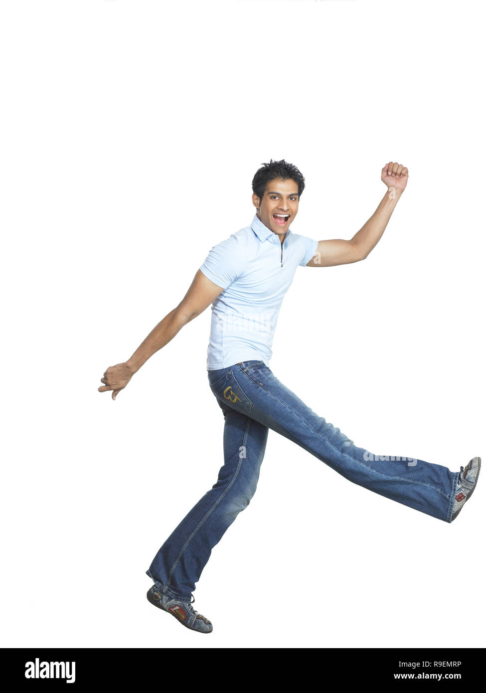 YOUNG MAN JUMPING IN EXUBERANCE AGAINST A WHITE BACKGROUND Stock Photo ...