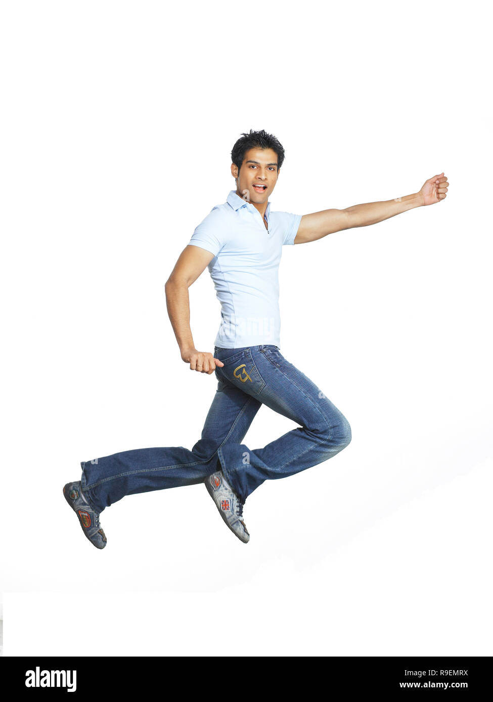 YOUNG MAN JUMPING IN EXUBERANCE AGAINST A WHITE BACKGROUND Stock Photo ...