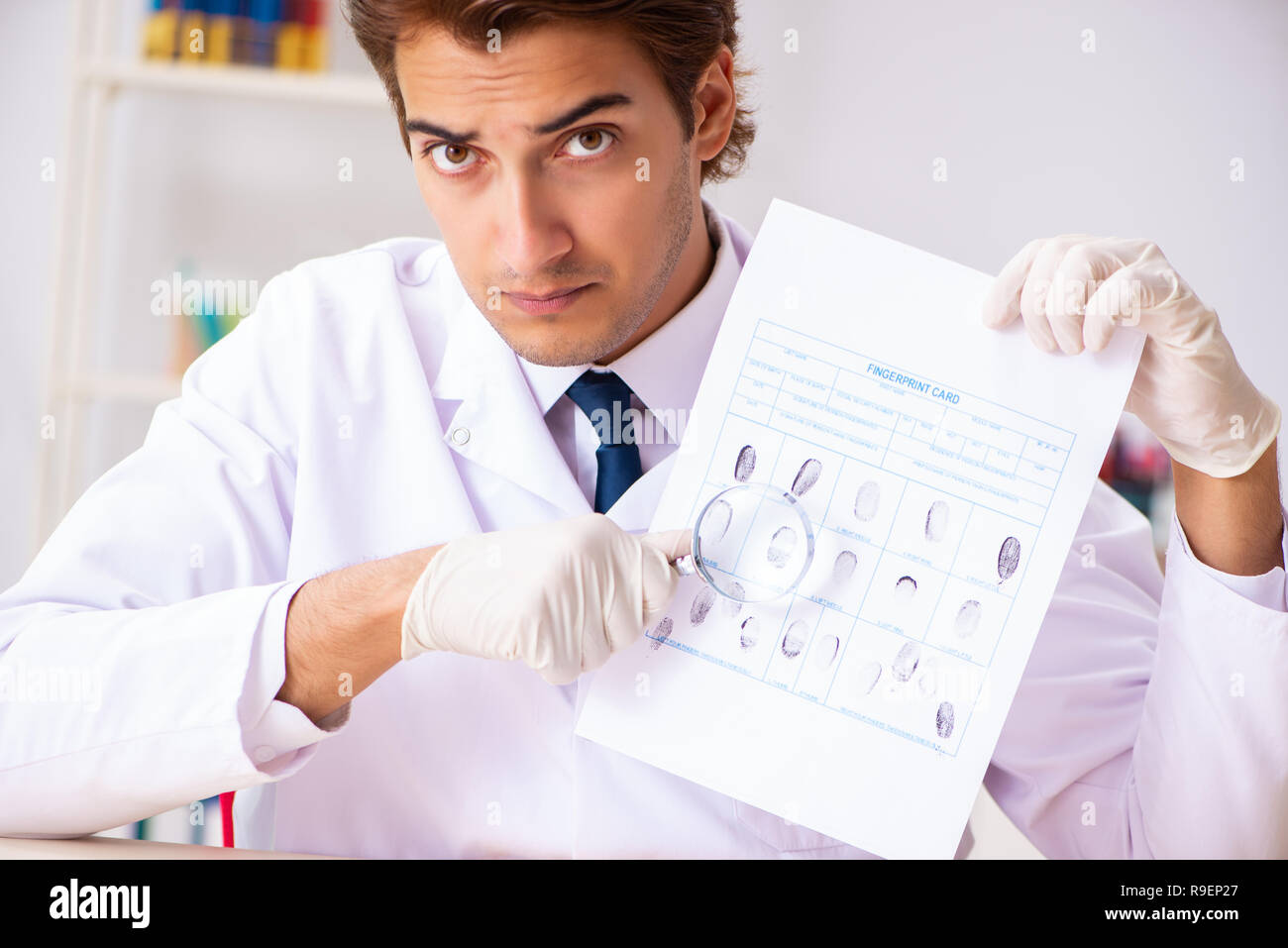 Forensic expert studying fingerprints in the lab Stock Photo - Alamy