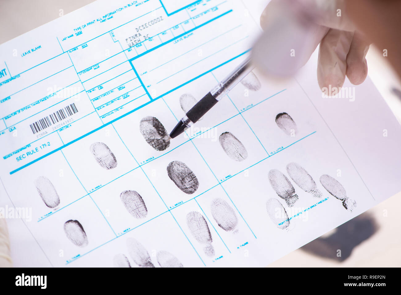 Forensic expert studying fingerprints in the lab Stock Photo - Alamy