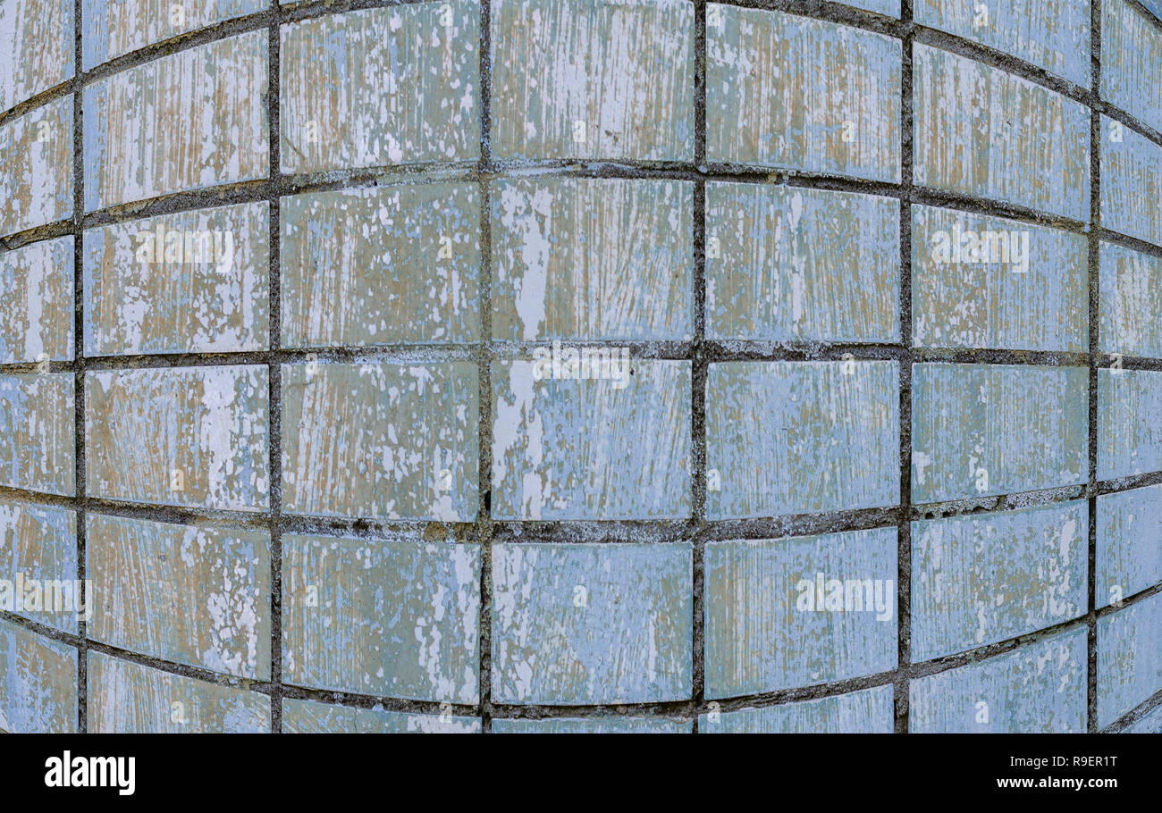 Wall is covered with old rough shabby blue tiles. Can be used as ...