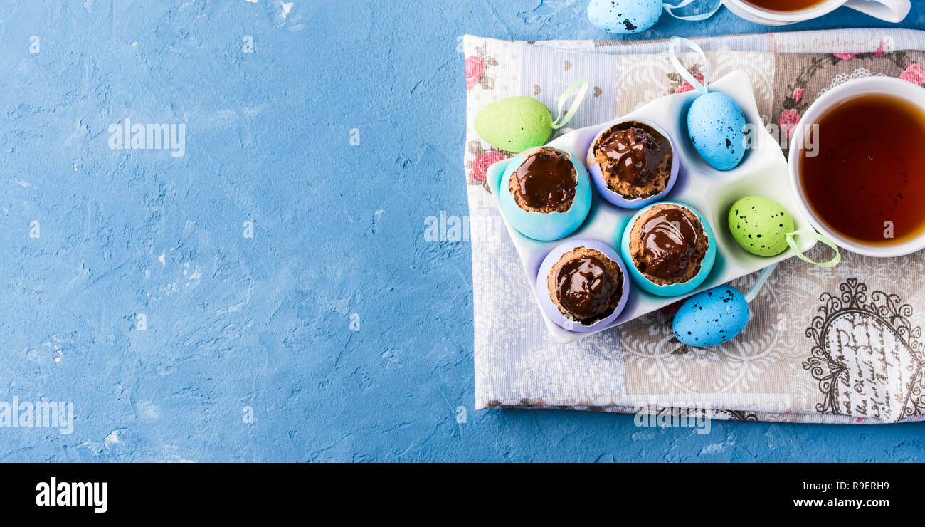 Easter blue background with cakes in colorful egg shells Stock Photo ...