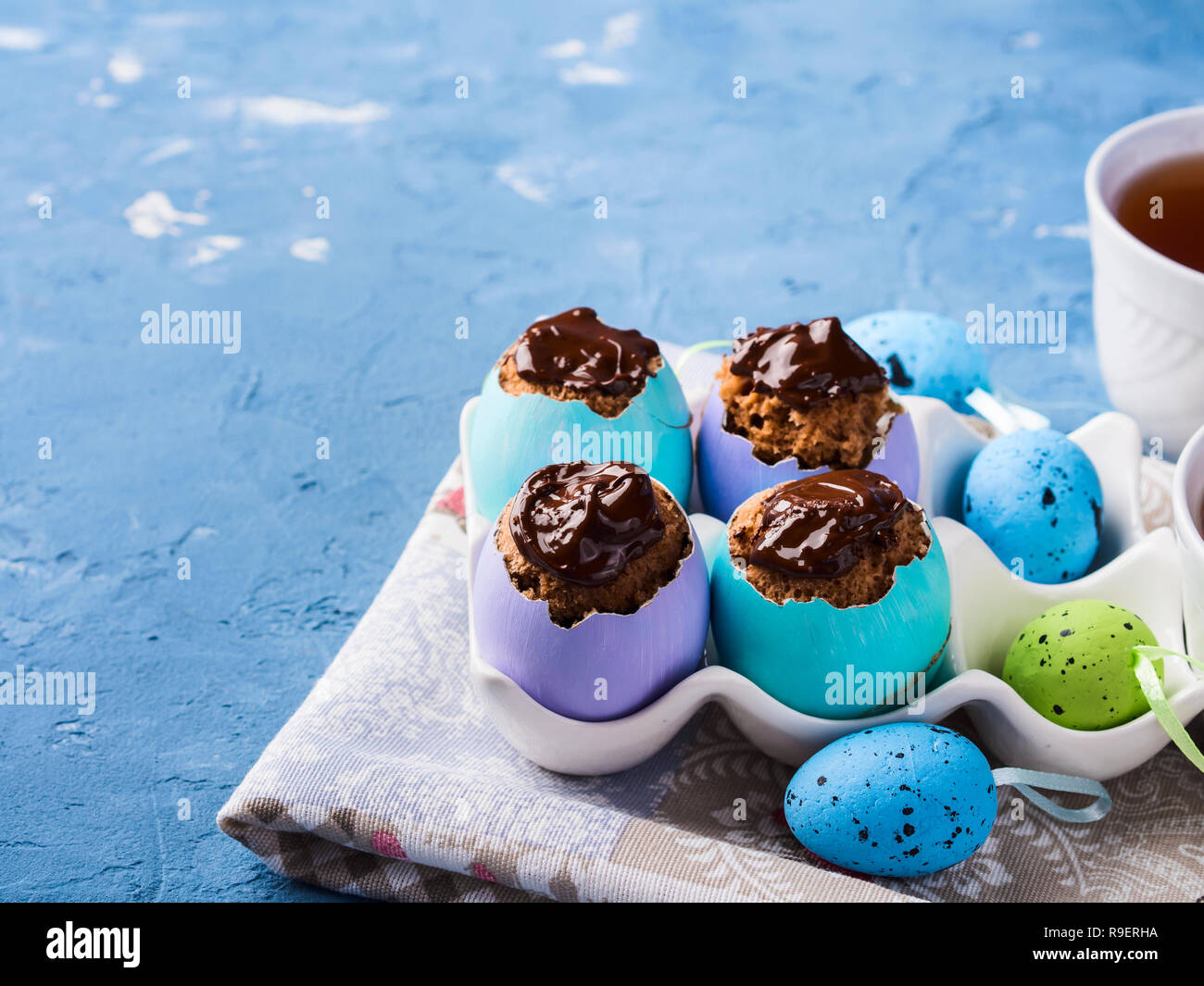 Easter blue background with cakes in colorful egg shells Stock Photo ...