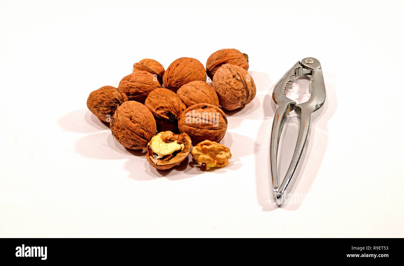 Nuts and claw to break nuts on a white background Stock Photo - Alamy