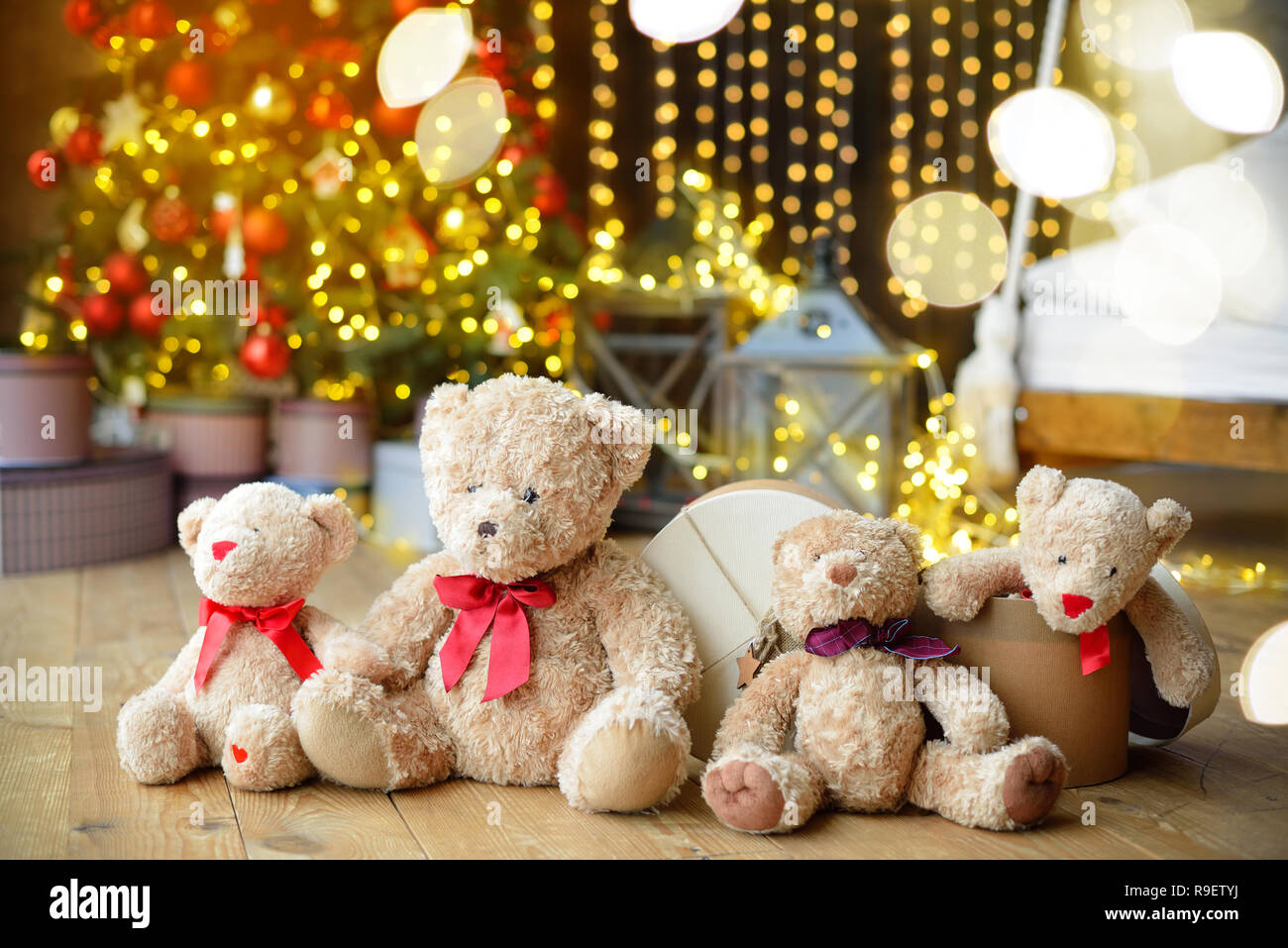 Family of teddy bears siting under the christmas tree with presents ...